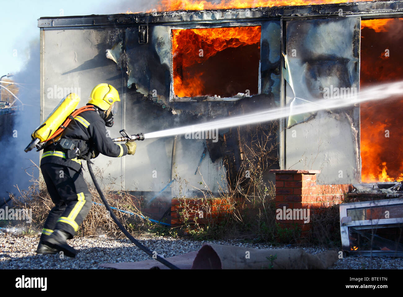 Fire Fighter tackling a blaze Stock Photo - Alamy