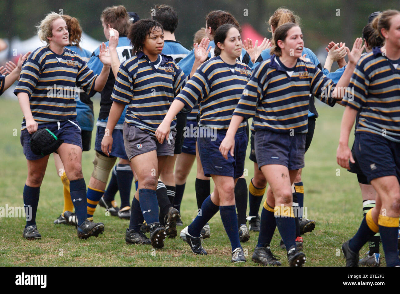 Naval Academy women rugby players shake hands with the opposing team ...