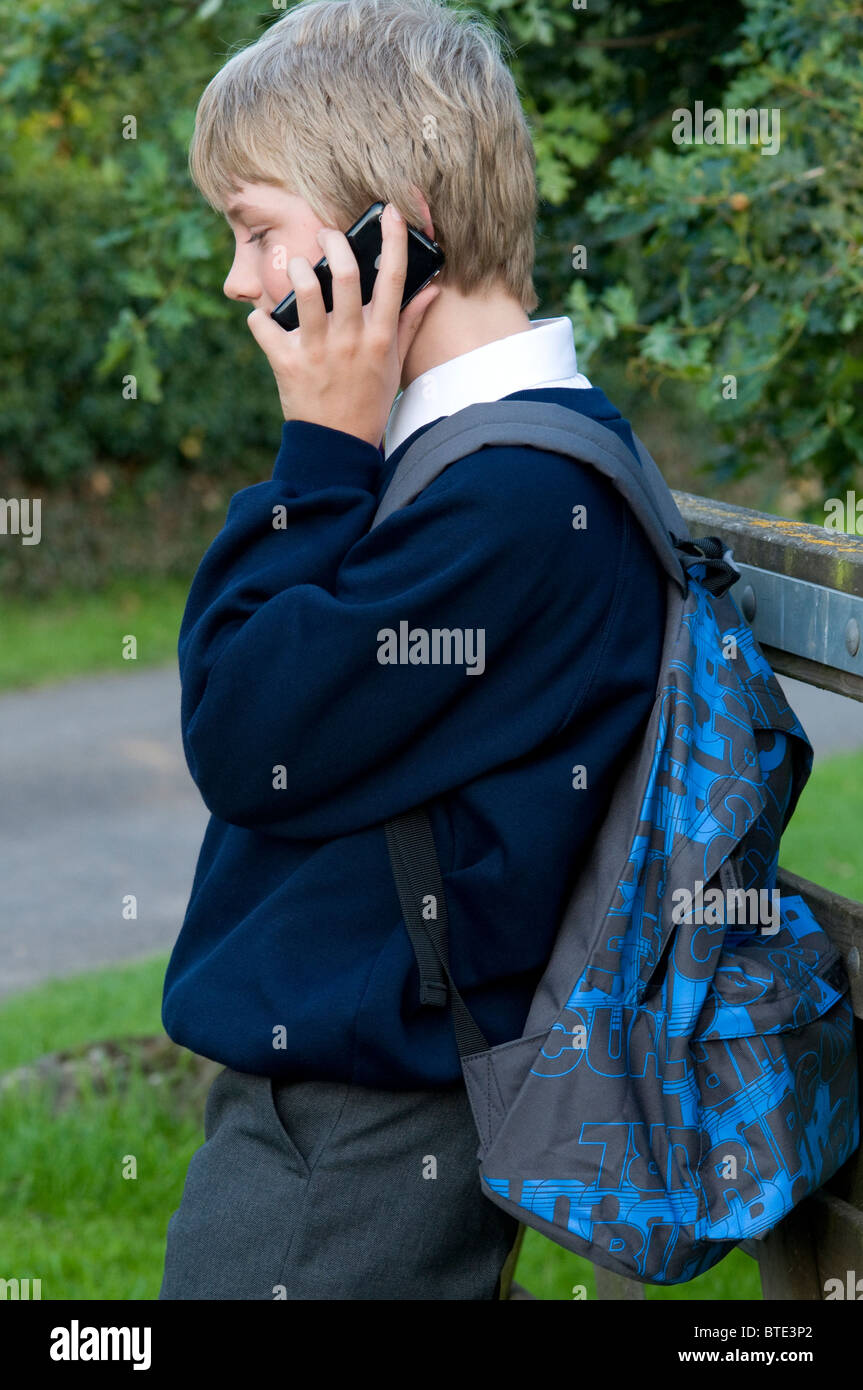 Schoolboy using mobile phone Stock Photo - Alamy