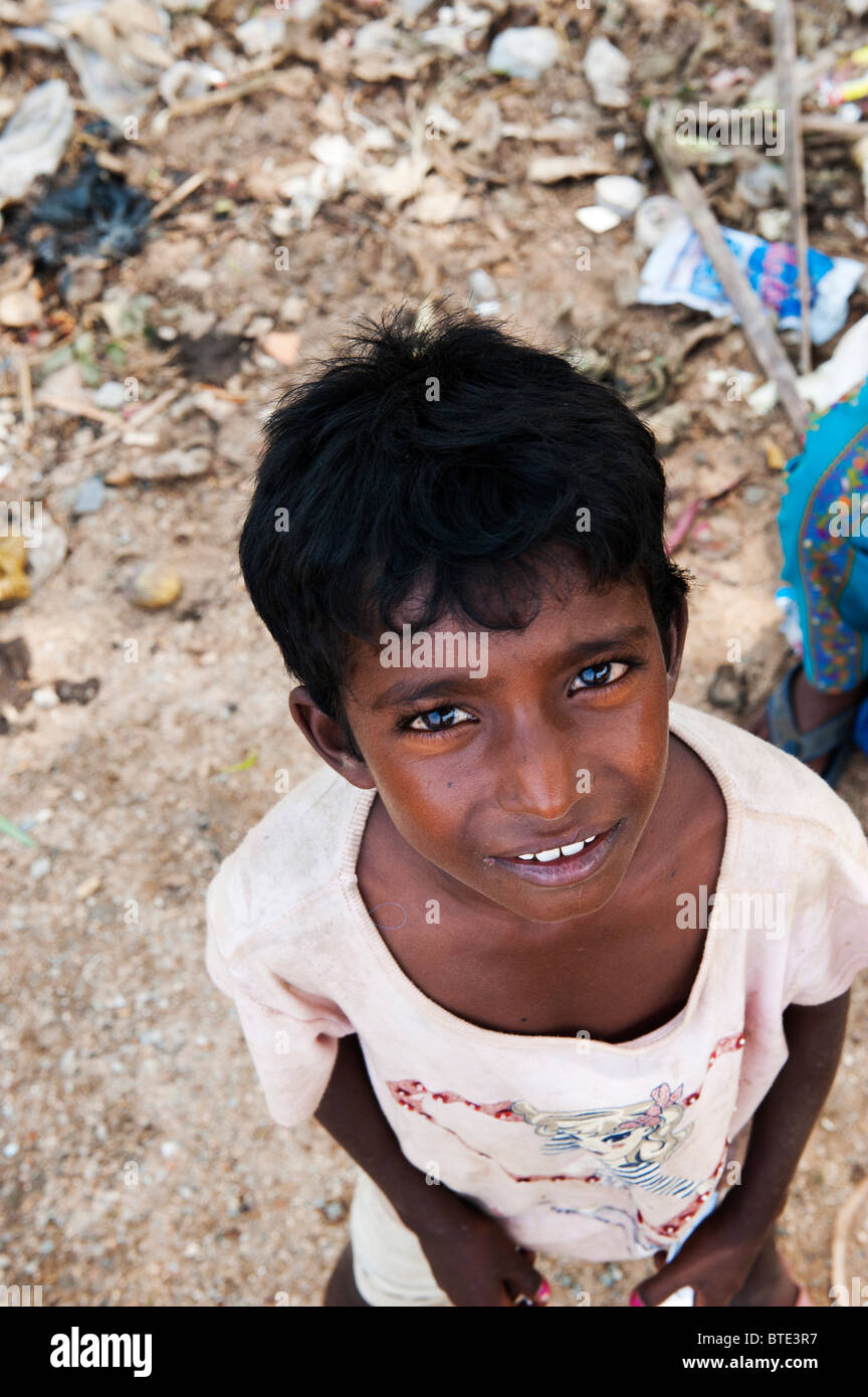 Indian street boy looking up by a rubbish tip in India Stock Photo - Alamy