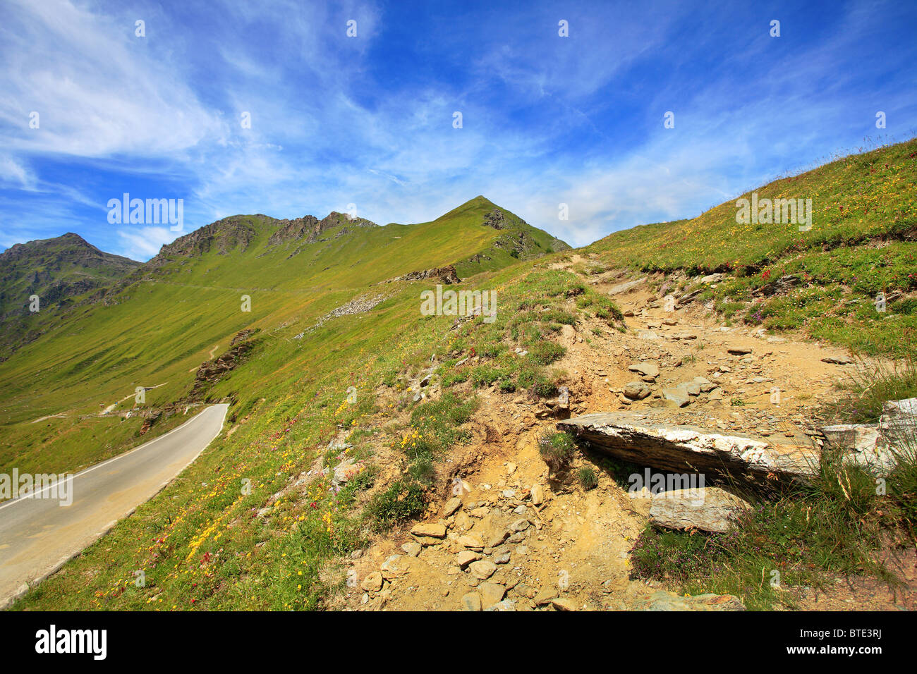 Alpine road, peaks and meadows in Alps, Italy Stock Photo - Alamy