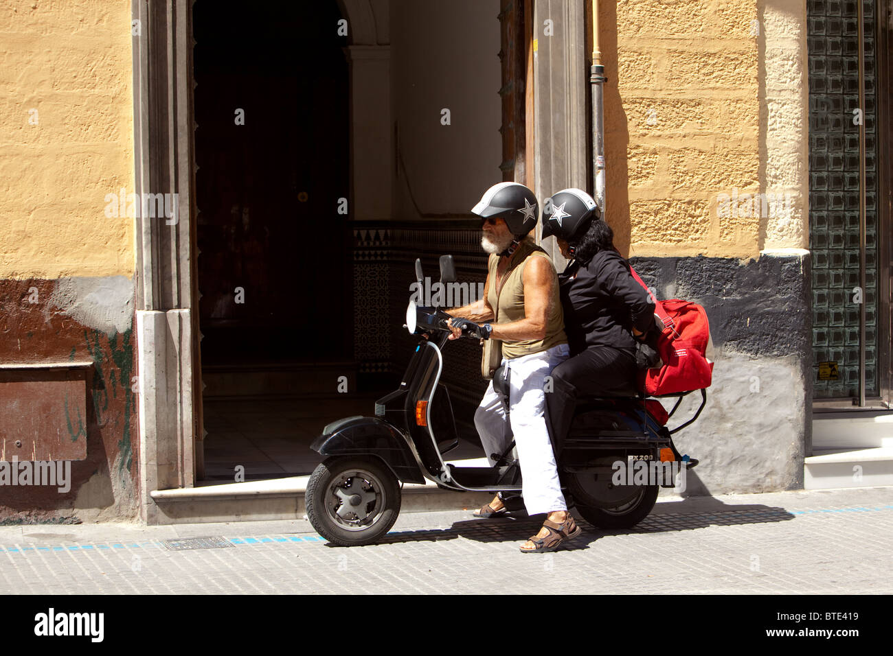 motor scooter driver and passenger Stock Photo - Alamy