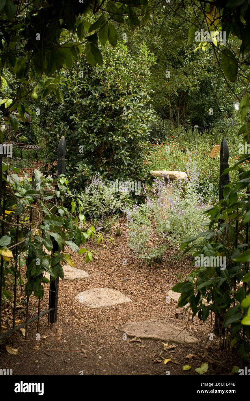 Open gate and stone path leading into the garden Stock Photo - Alamy