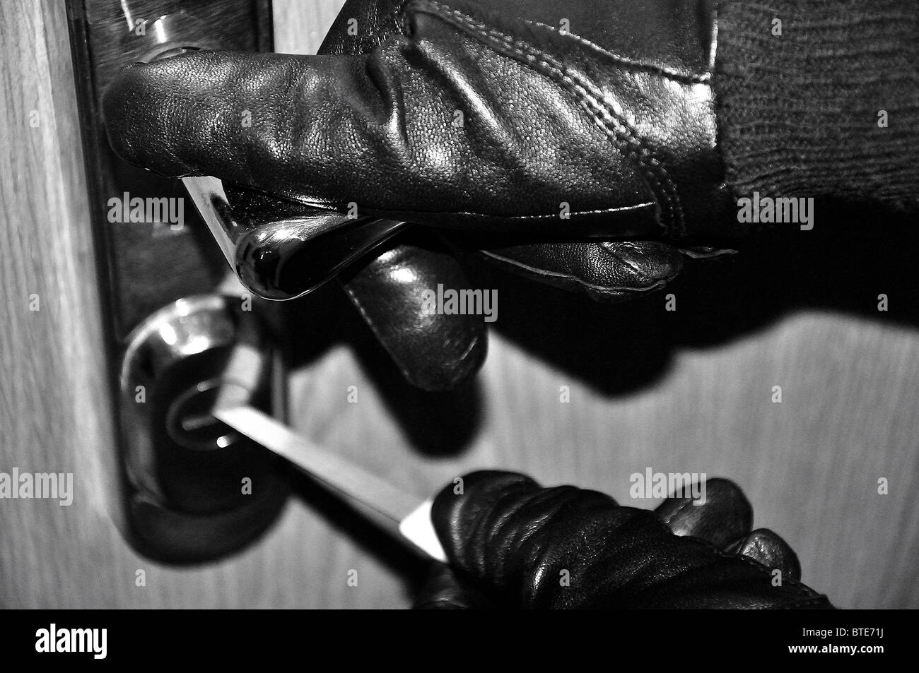 Burglar hands in action for breaking the lock Stock Photo - Alamy