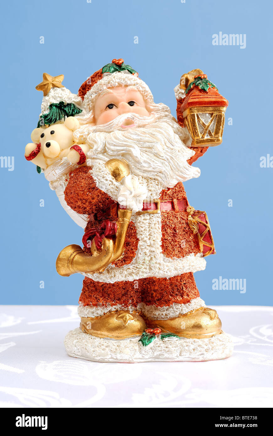 Santa Claus statuette opposite blue background Stock Photo - Alamy