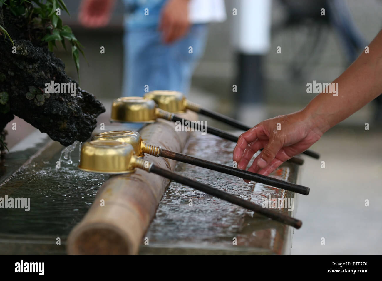 Washing hands at purification trough before entering a Buddhist temple ...