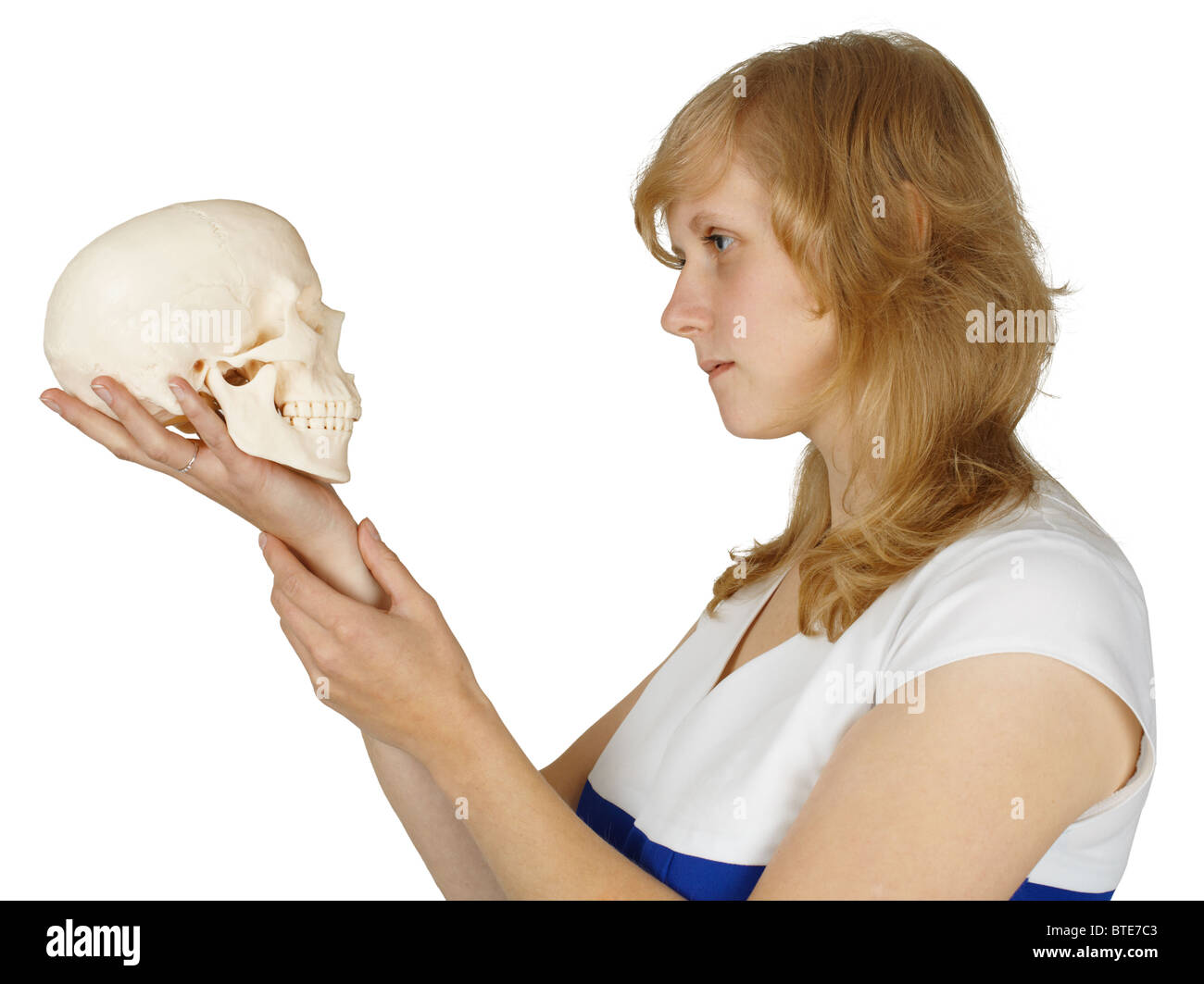 A woman examines a human skull isolated on white background Stock Photo ...