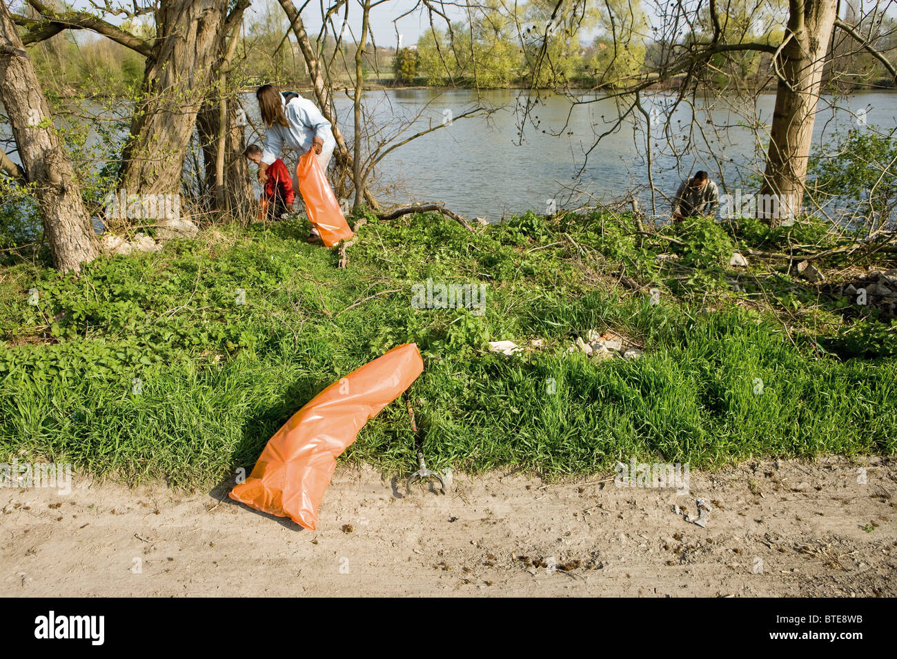 Volunteers picking up trash outdoors Stock Photo - Alamy