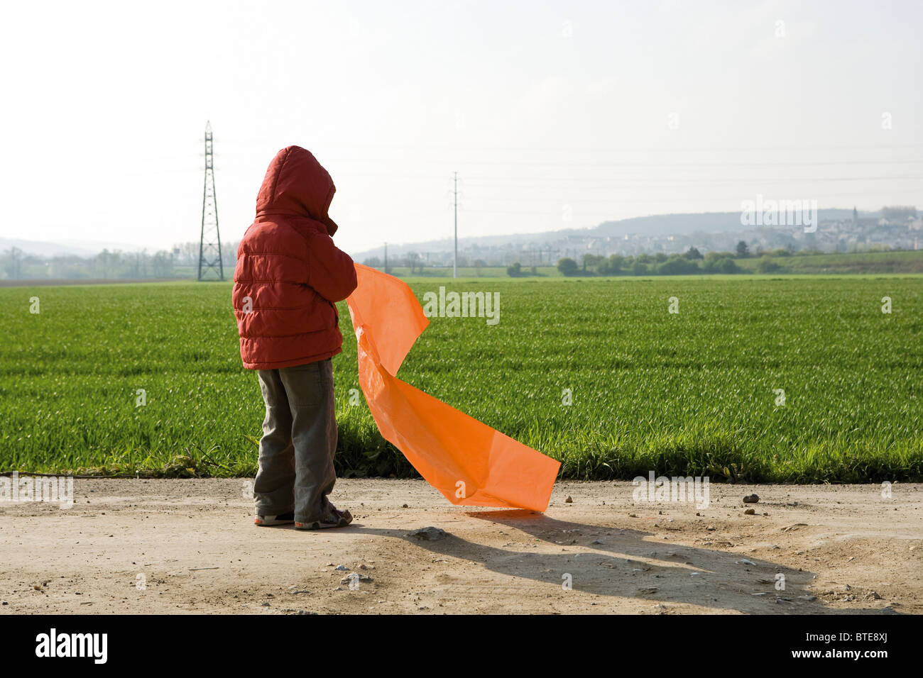 Child with plastic bag, rear view Stock Photo - Alamy