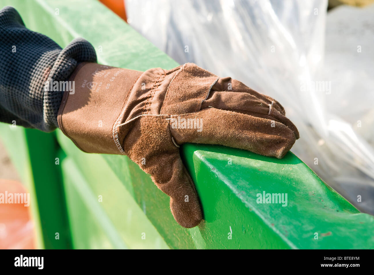 Gloved hand holding onto edge hi-res stock photography and images - Alamy