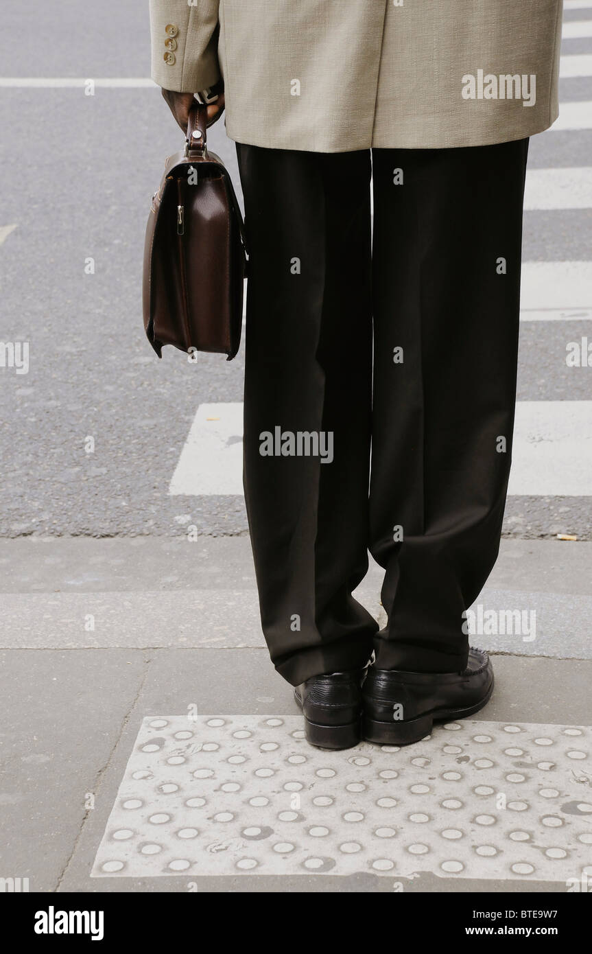 Pedestrian waiting at crosswalk, cropped Stock Photo - Alamy