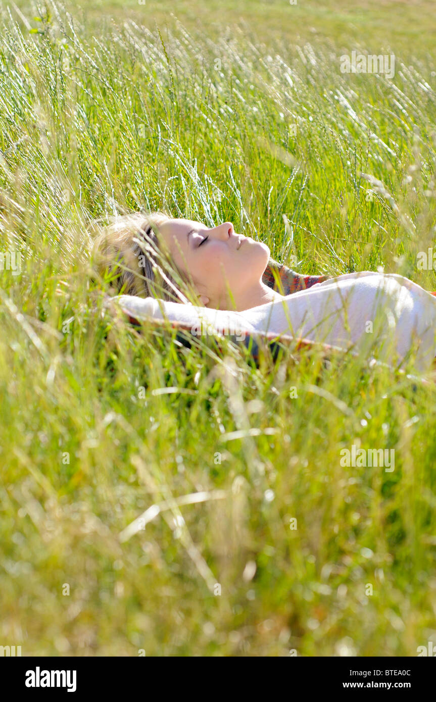 Woman taking nap on grass hi-res stock photography and images - Alamy