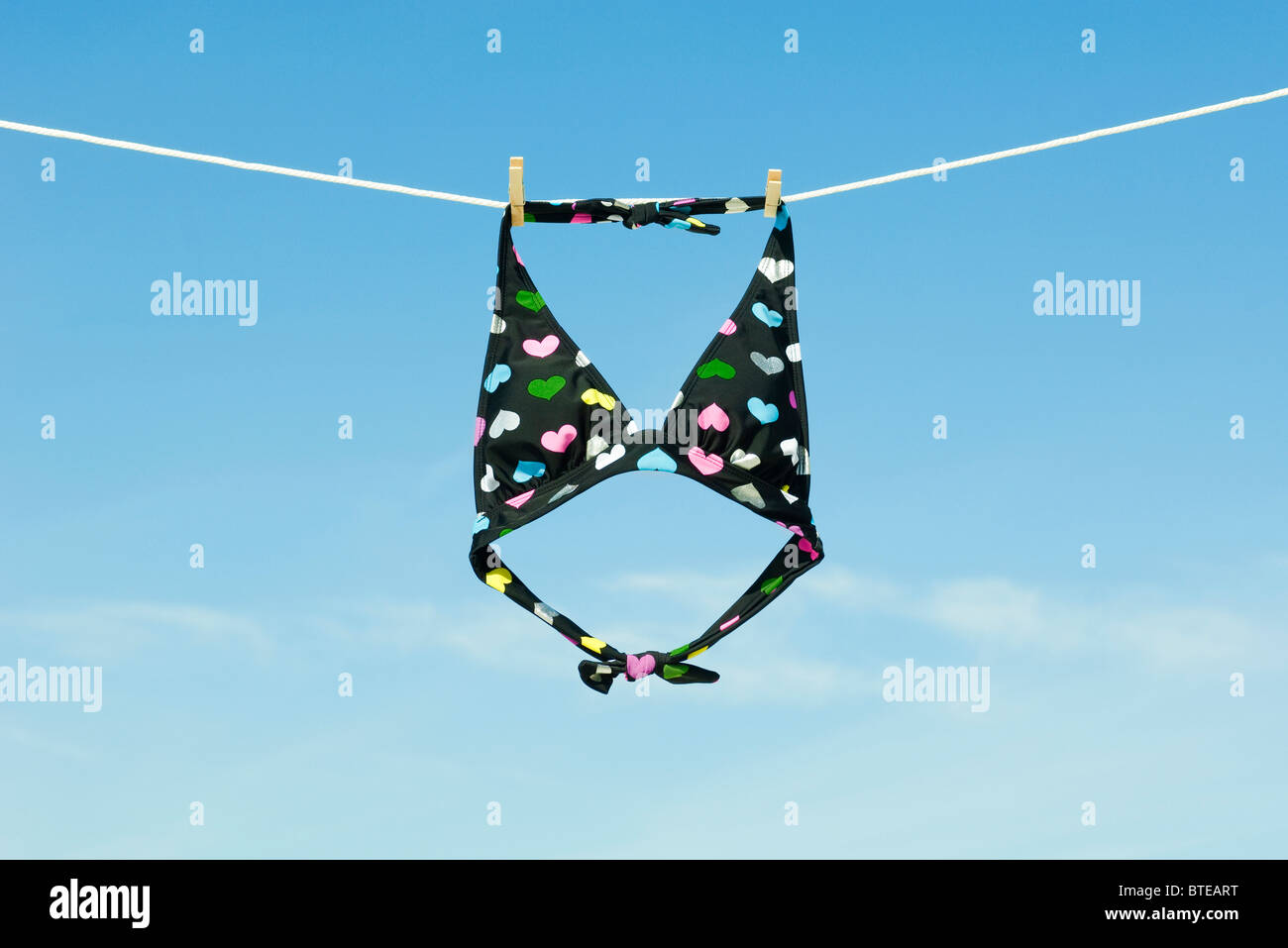 Bikini top hanging on clothes-line Stock Photo - Alamy