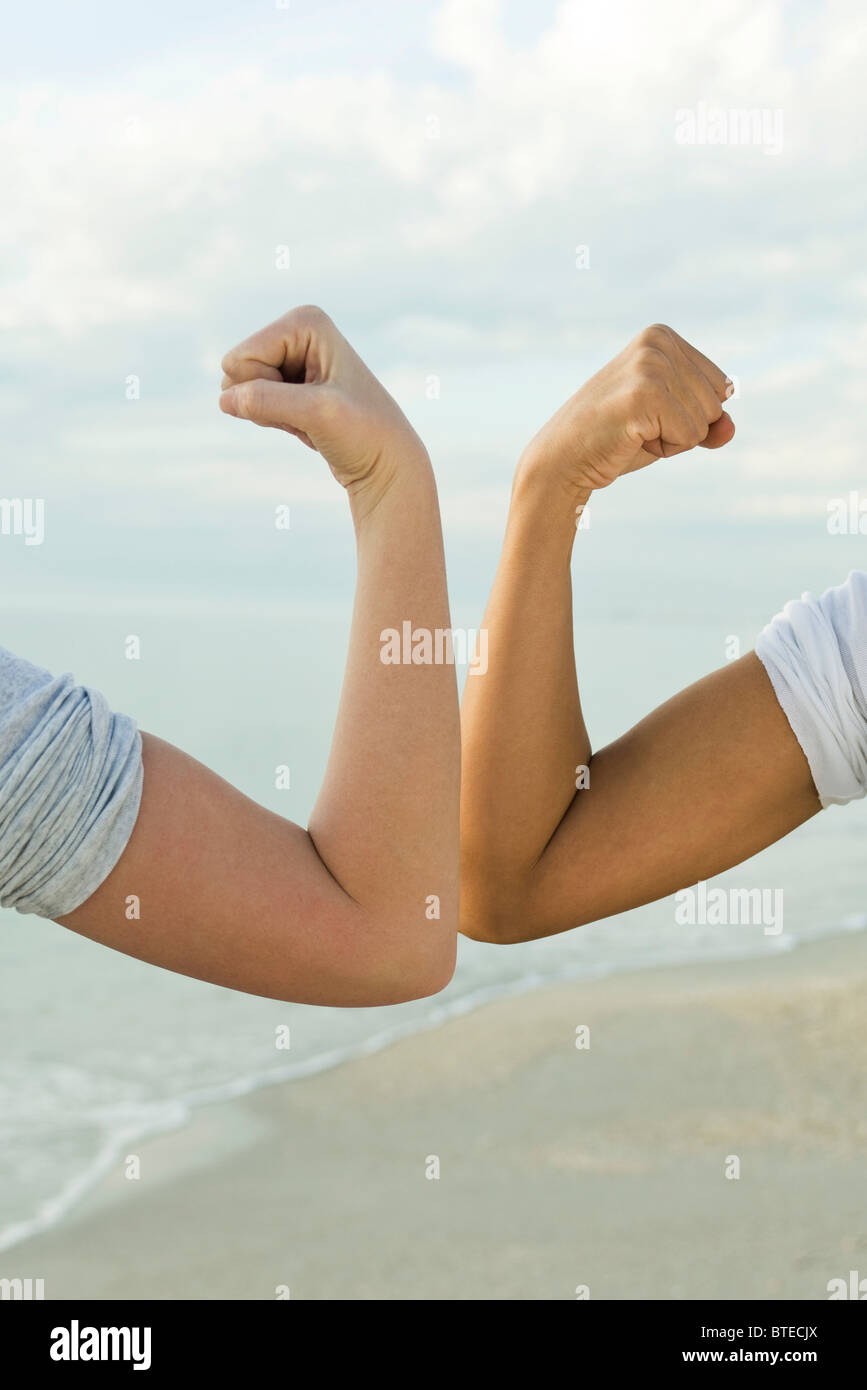 Women flexing arms, cropped Stock Photo - Alamy