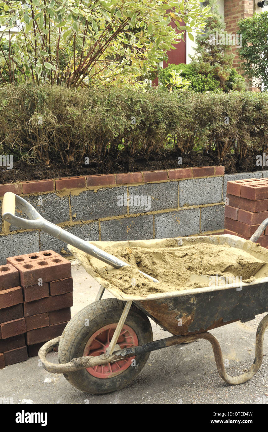 Bricks and mortar in a wheelbarrow Stock Photo - Alamy