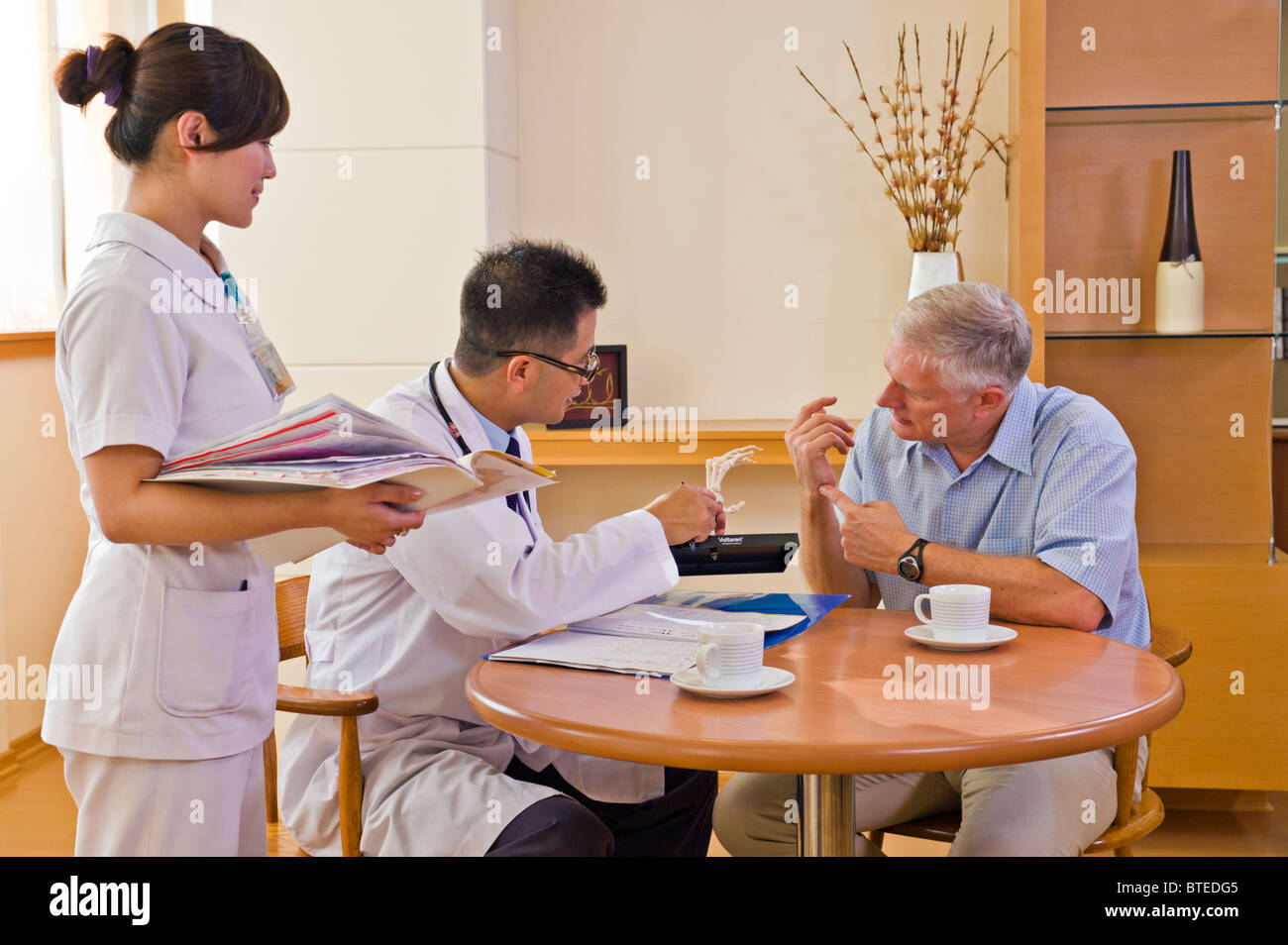 Doctor explaining to patient in hospital international health services ...