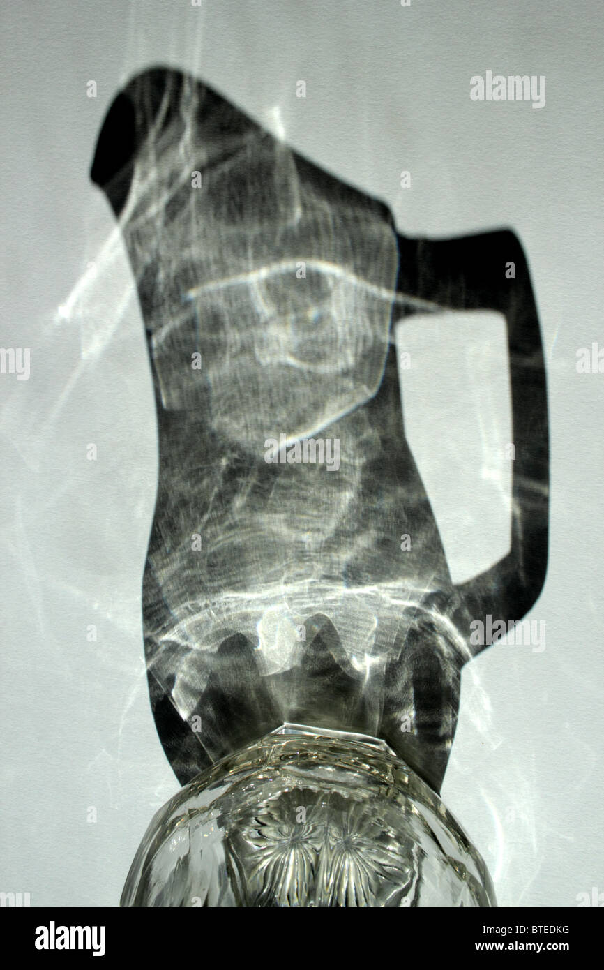 Glass vase jug with shadow on a white background Stock Photo - Alamy