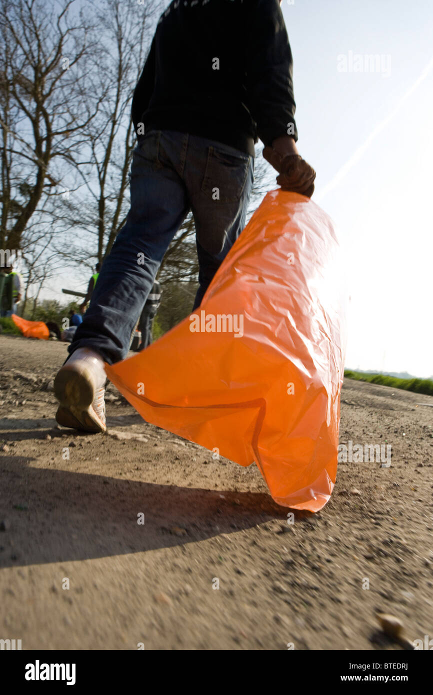 Walking with garbage bag Stock Photo - Alamy