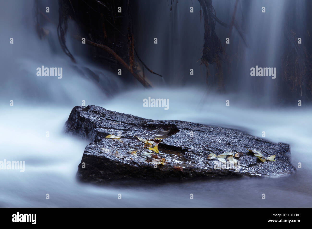 stone under waterfall in mountain river Stock Photo - Alamy