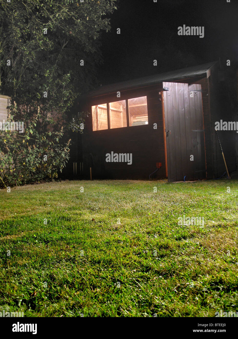 Shed with open door at night Stock Photo - Alamy