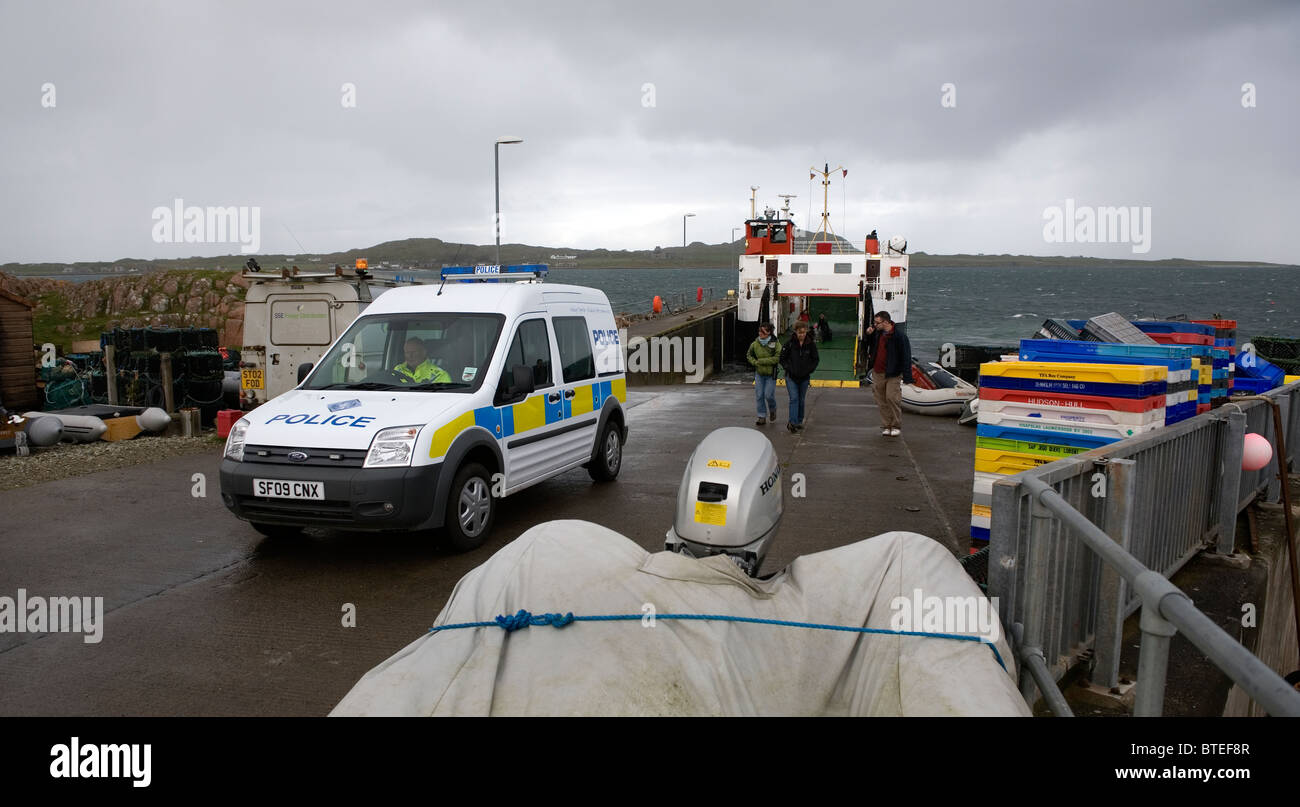 Isle of Mull looking to Iona, Scotland. Local Police leave the Iona ...