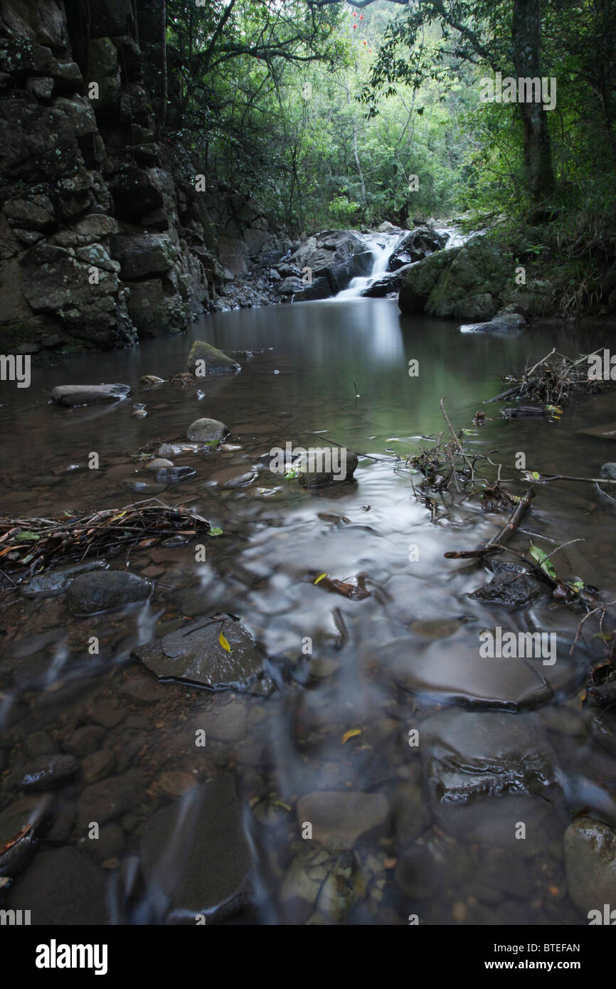 Shallow rocky stream leading to small waterfall Stock Photo - Alamy