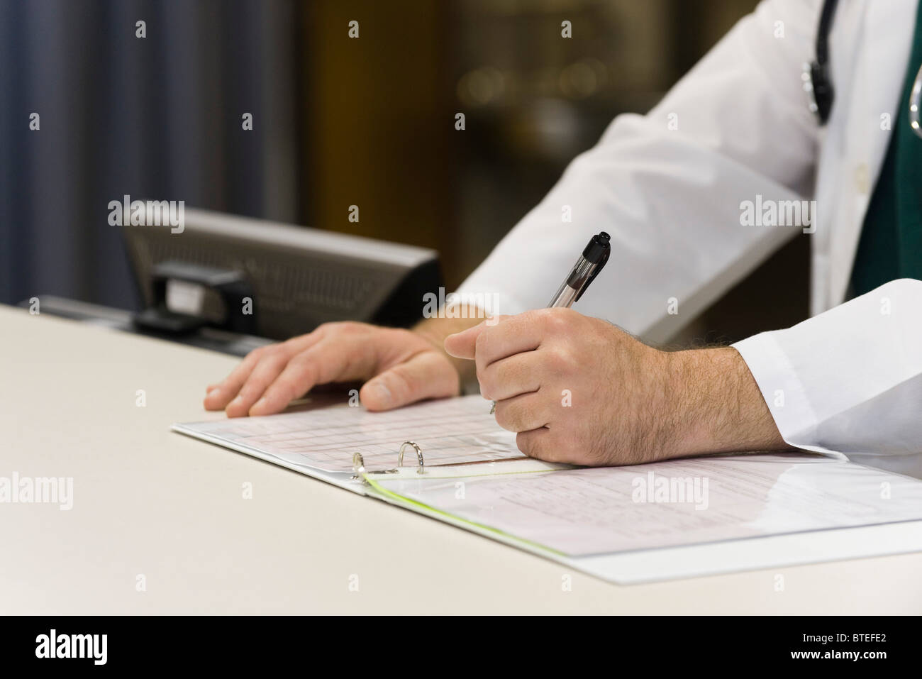Healthcare worker completing document Stock Photo - Alamy