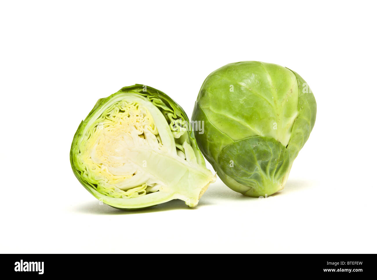 Whole and sliced Brussels Sprout from low perspective isolated against ...