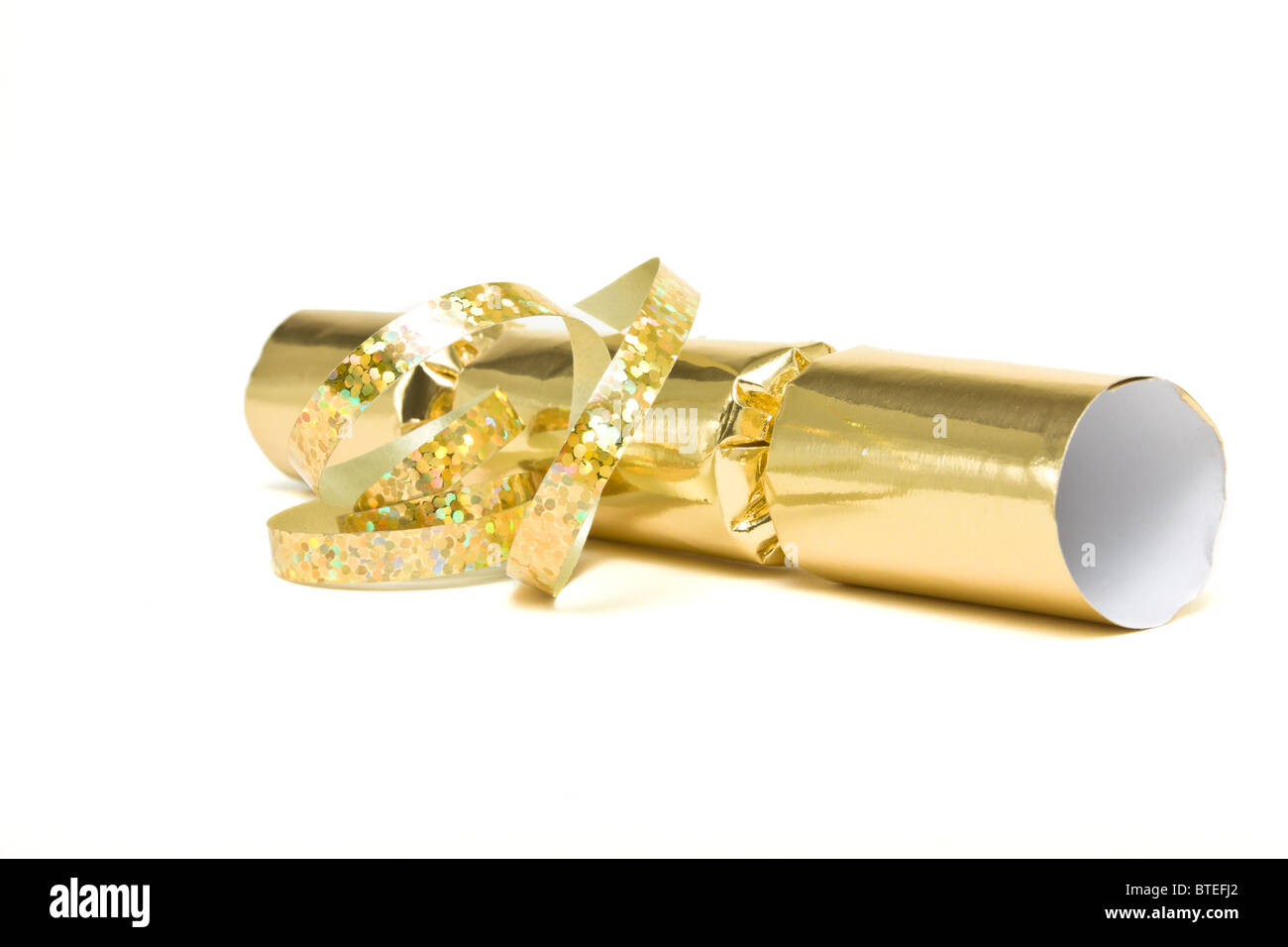 Golden Christmas Cracker with ribbon from low perspective Stock Photo ...