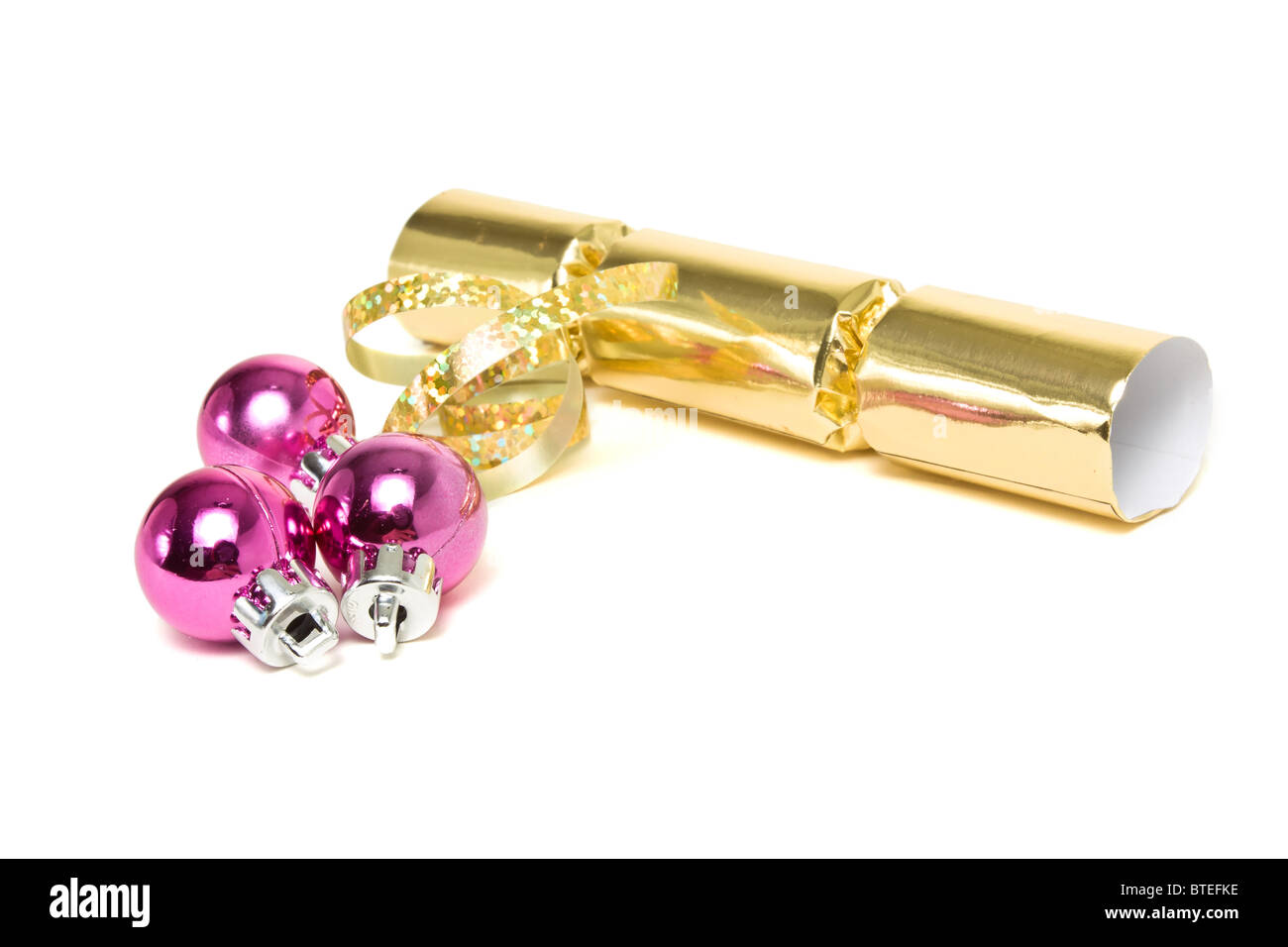 Golden Christmas Cracker with ribbon and baubles from low perspective ...