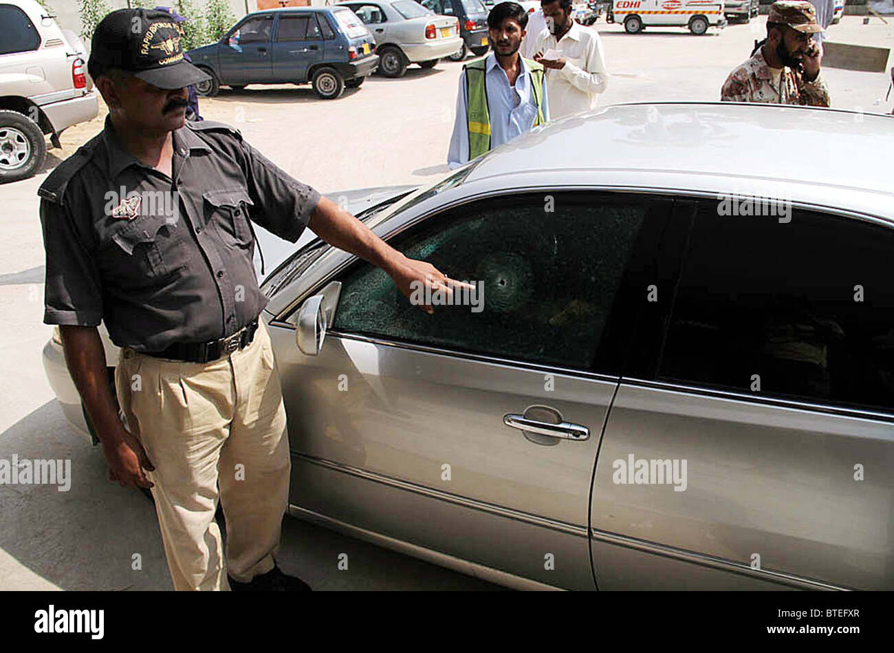 Police official points bullet sign at Japan Consulate vehicle after ...