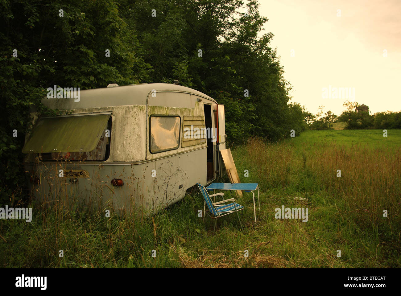 An old caravan standing on the field at sunrise (Location: Gotland ...