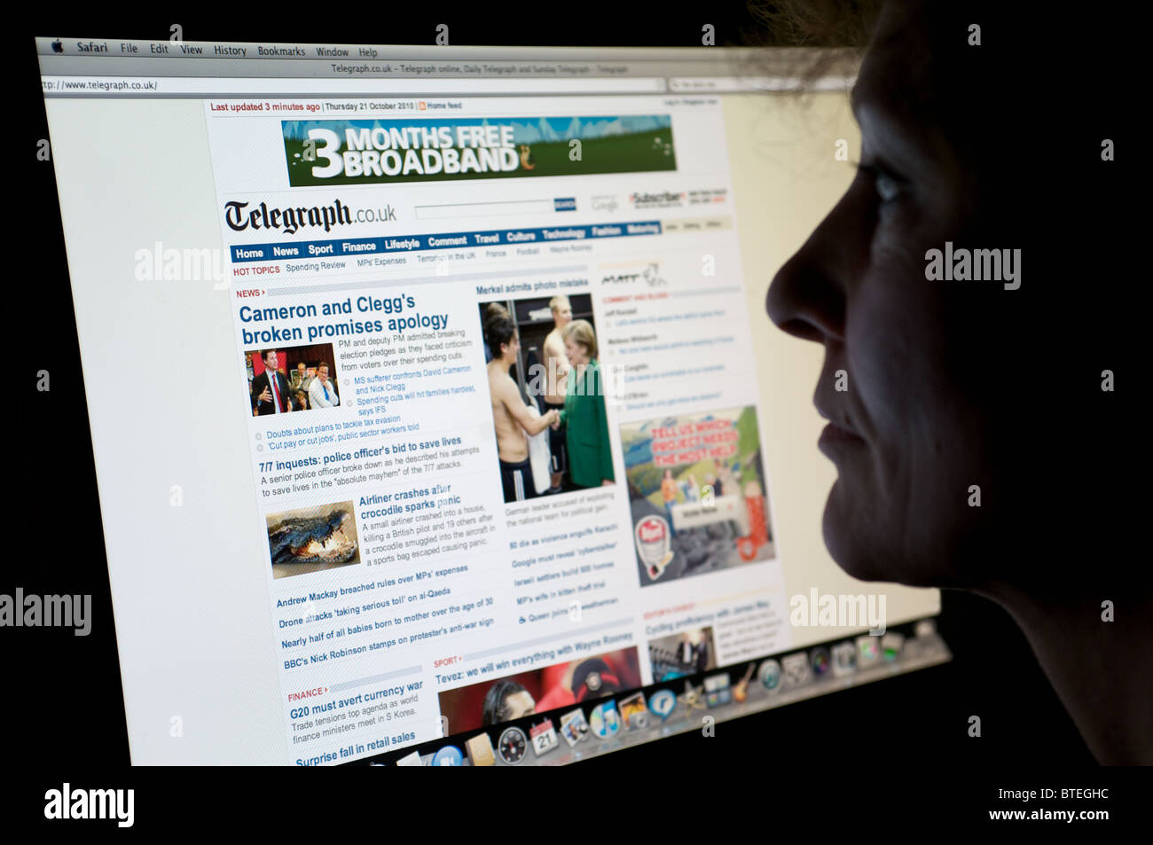 Woman reading a the Daily Telegraph online edition Stock Photo - Alamy