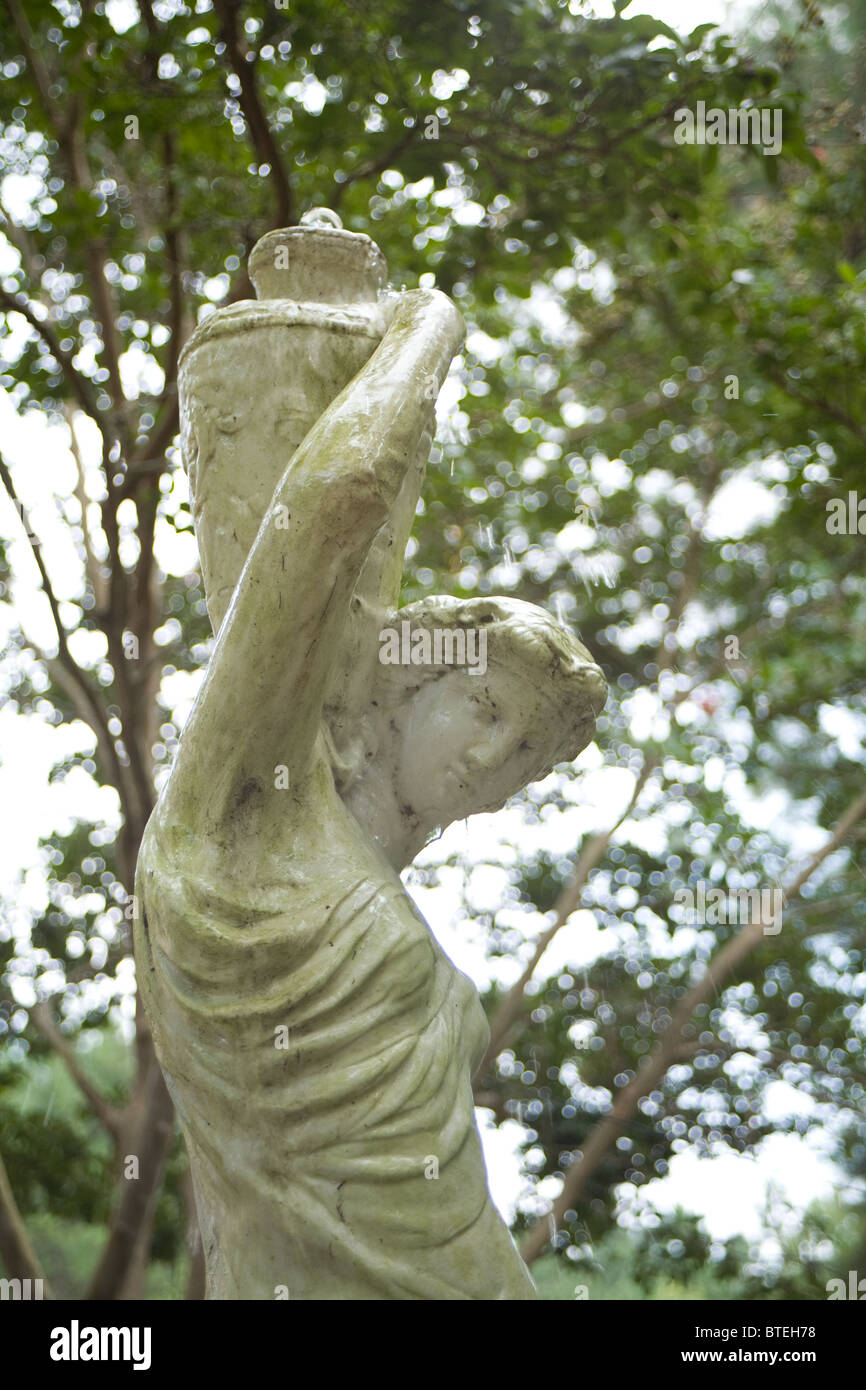 Detail of statue depicting a woman carrying a jug of water Stock Photo ...