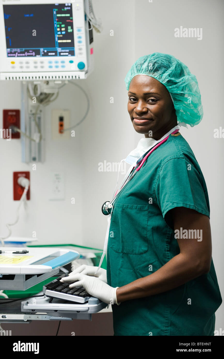 Nurse using computer in hospital room Stock Photo - Alamy