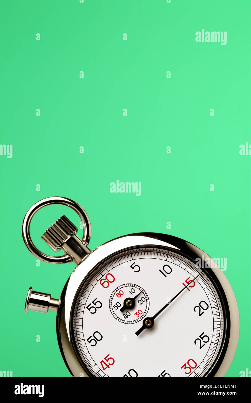 A stopwatch timing device floating on a green background Stock Photo ...