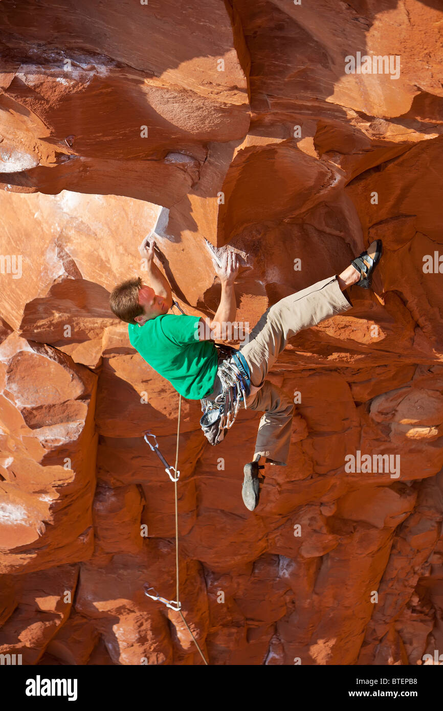 Climber clings to the side of an overhanging rock face in Sedona, AZ ...