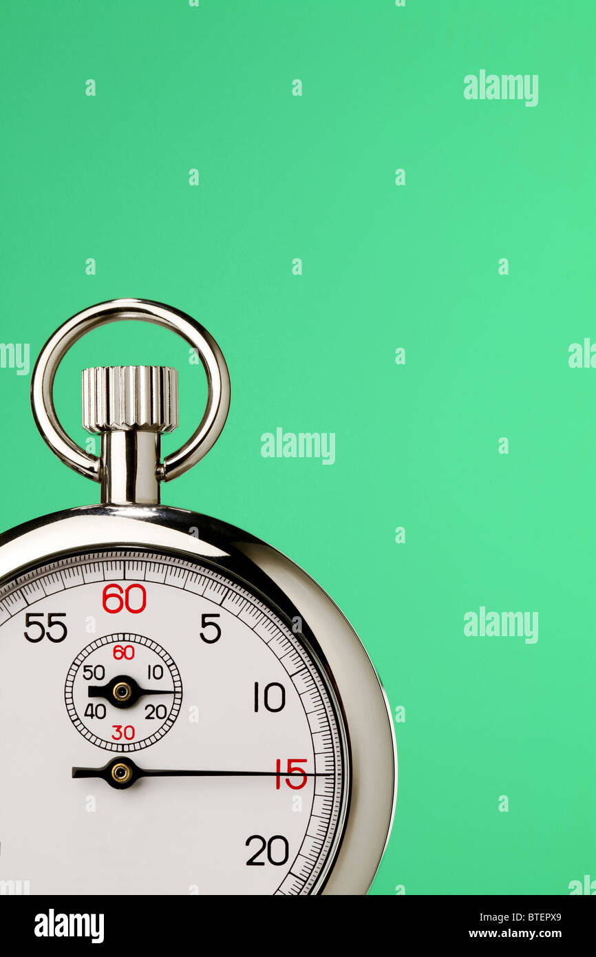A stopwatch timing device floating on a green background Stock Photo ...