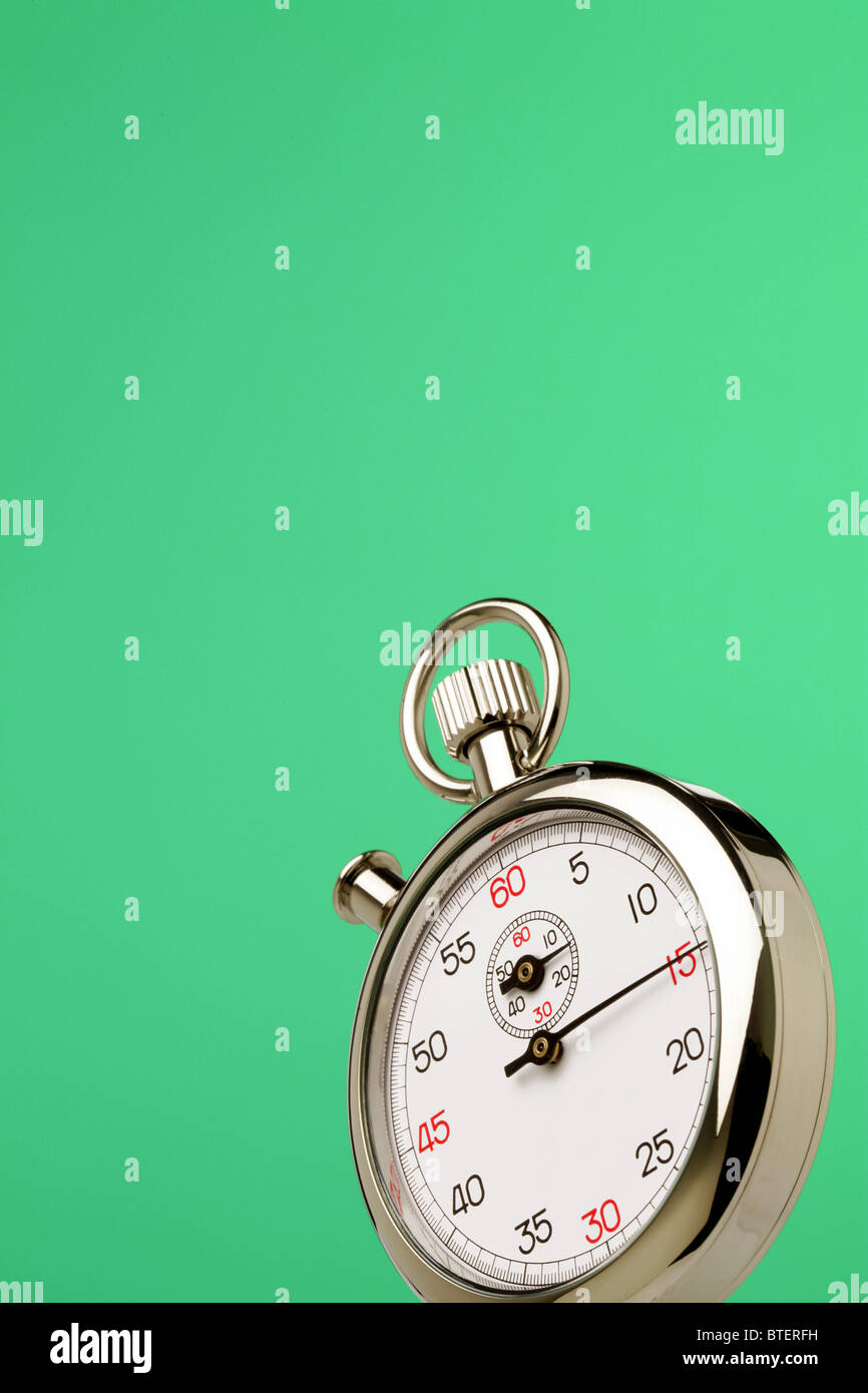 A stopwatch timing device floating on a green background Stock Photo ...