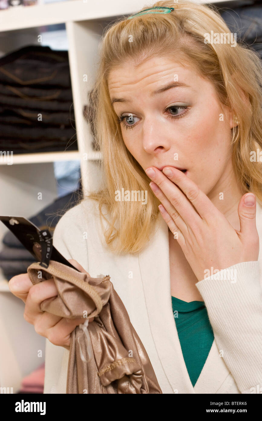 Shocked woman looking price tag hi-res stock photography and images - Alamy