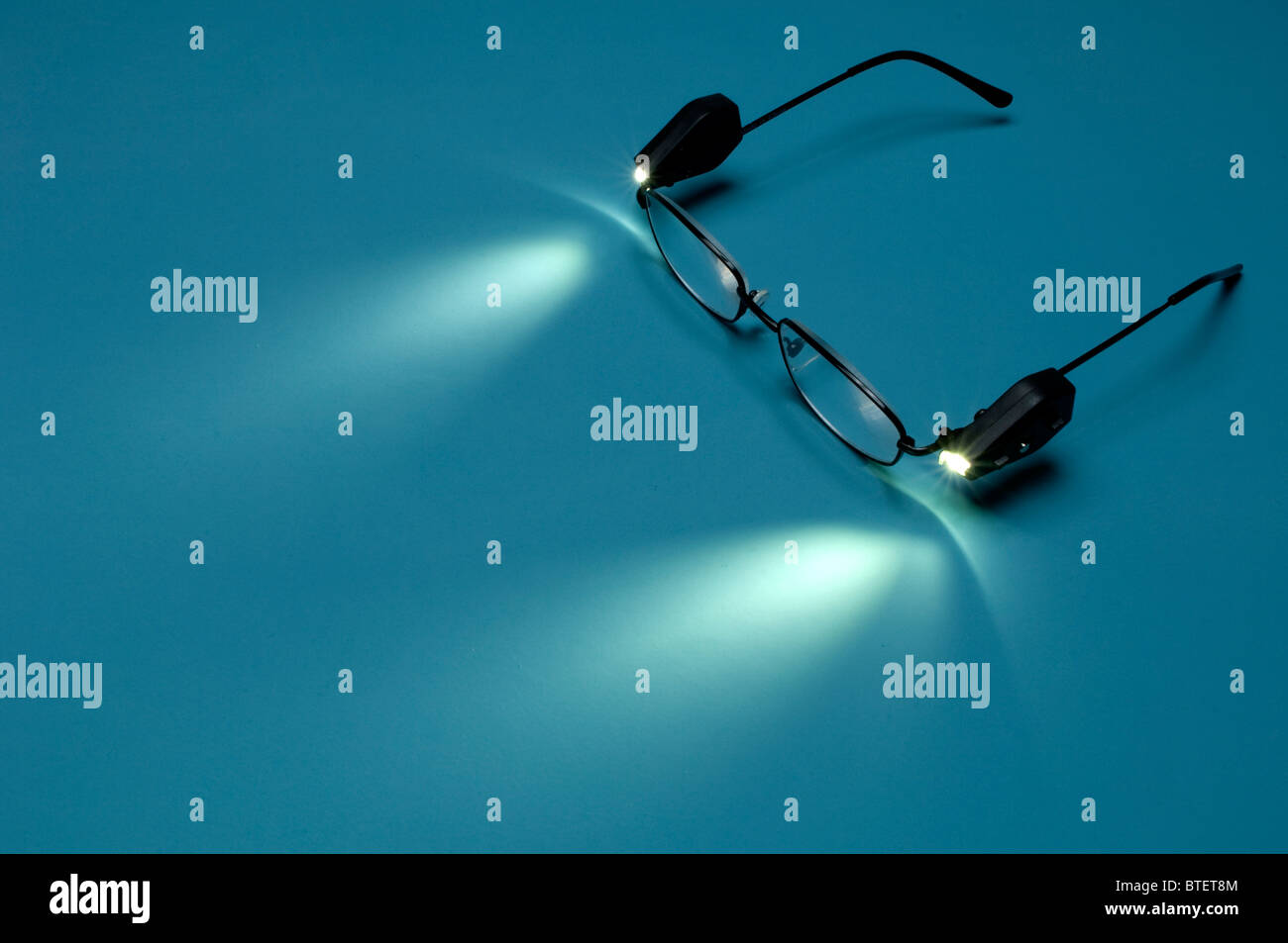 Reading eyeglasses with small lights attached to the frames. Light is ...