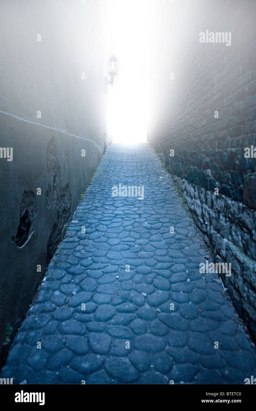 Cobblestone road with bright light Stock Photo - Alamy