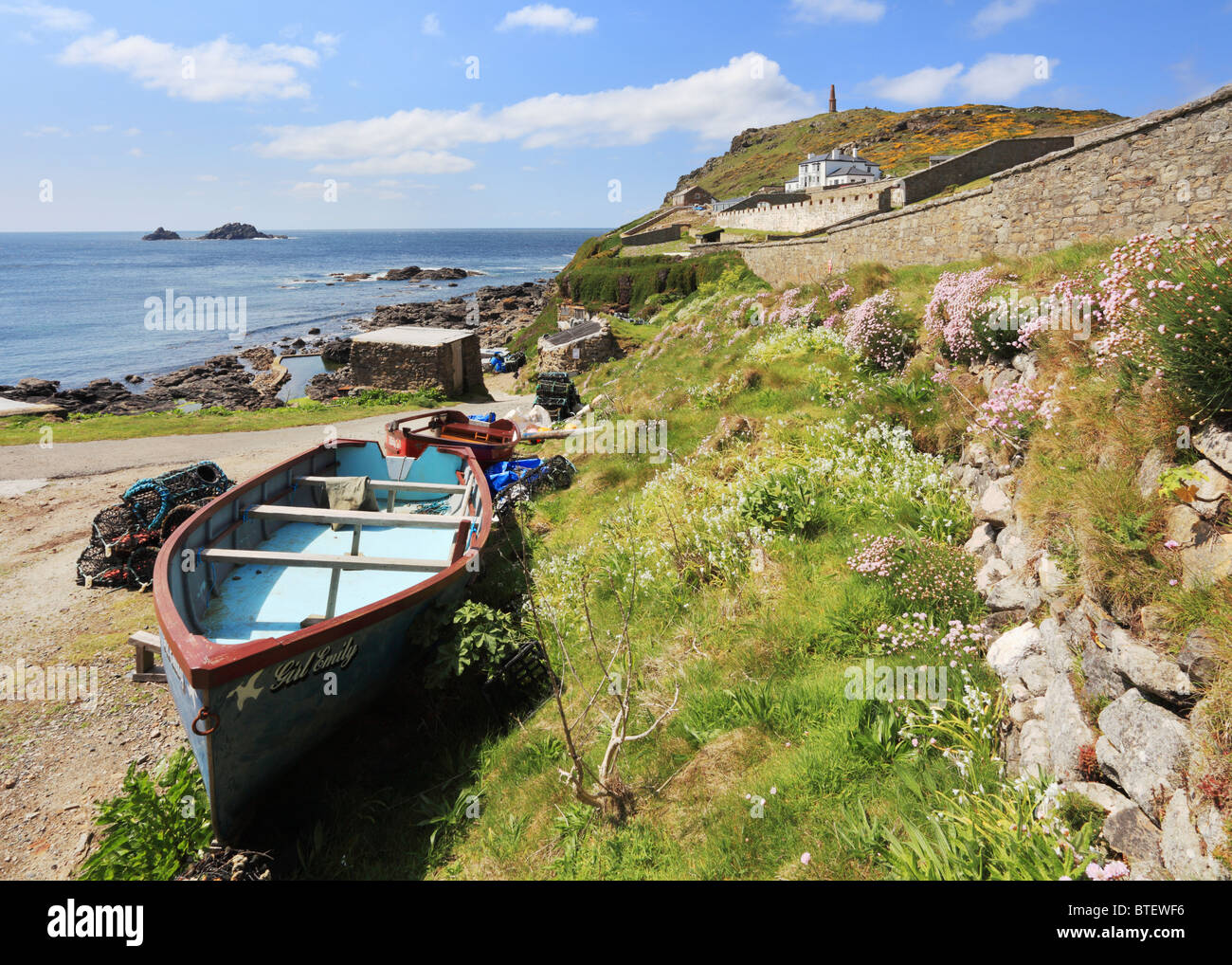 Cape Cormwall captured in the spring with a boat in the foreground and ...