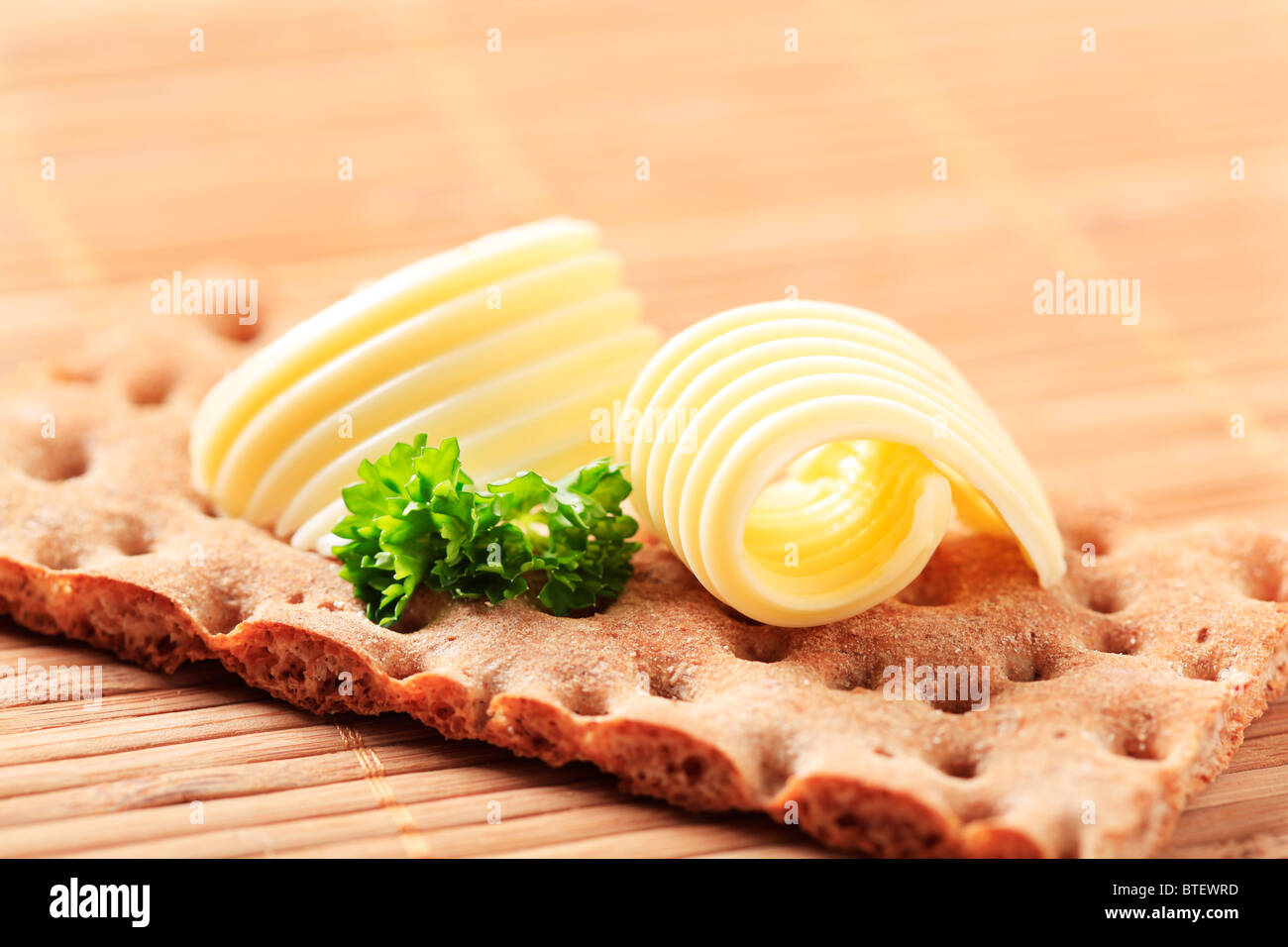 Two butter curls on a whole grain cracker Stock Photo - Alamy