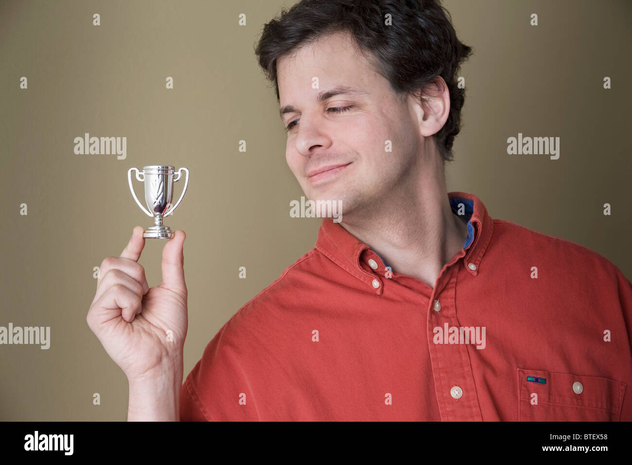 Man holding trophy cup hi-res stock photography and images - Alamy