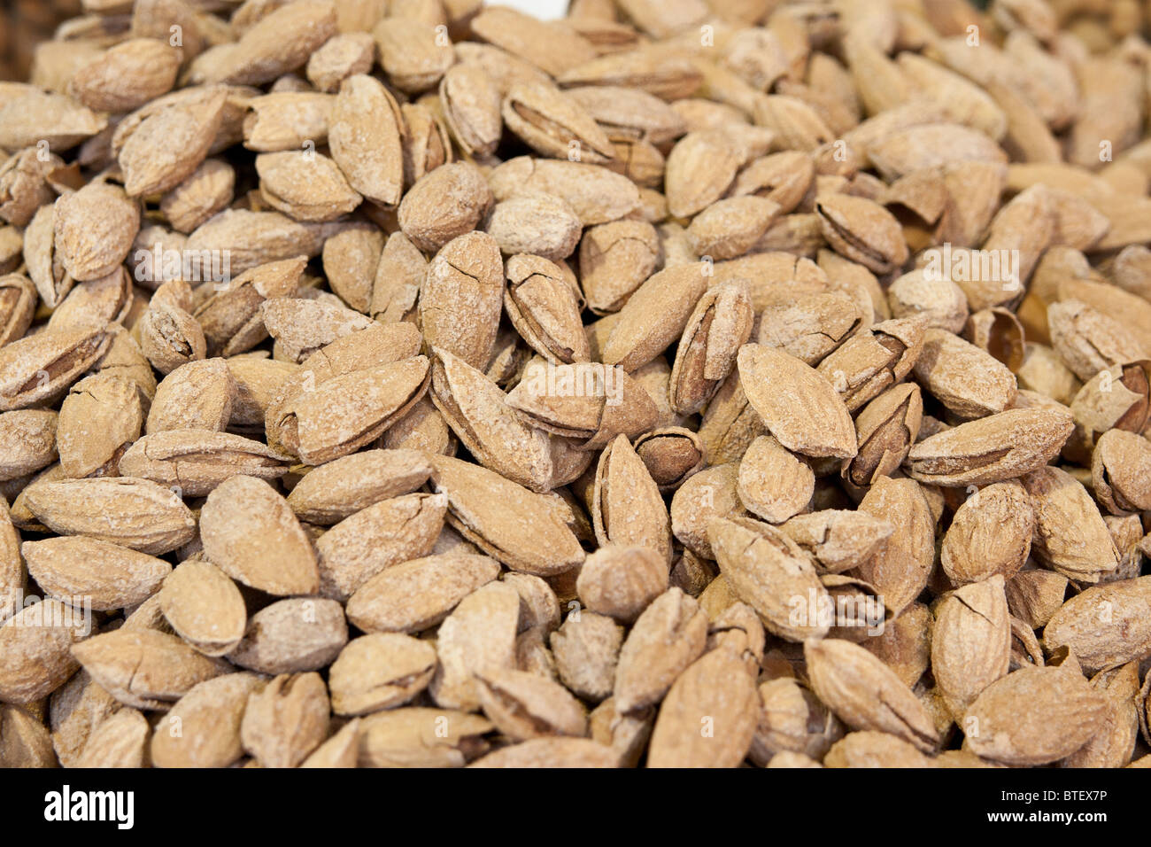 Big pile of raw almonds in shells Stock Photo - Alamy