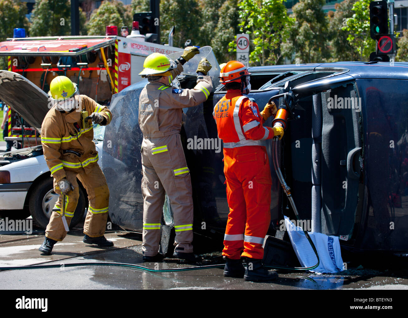 Emergency rescue workers cut a person out of a crashed vehicle Stock ...