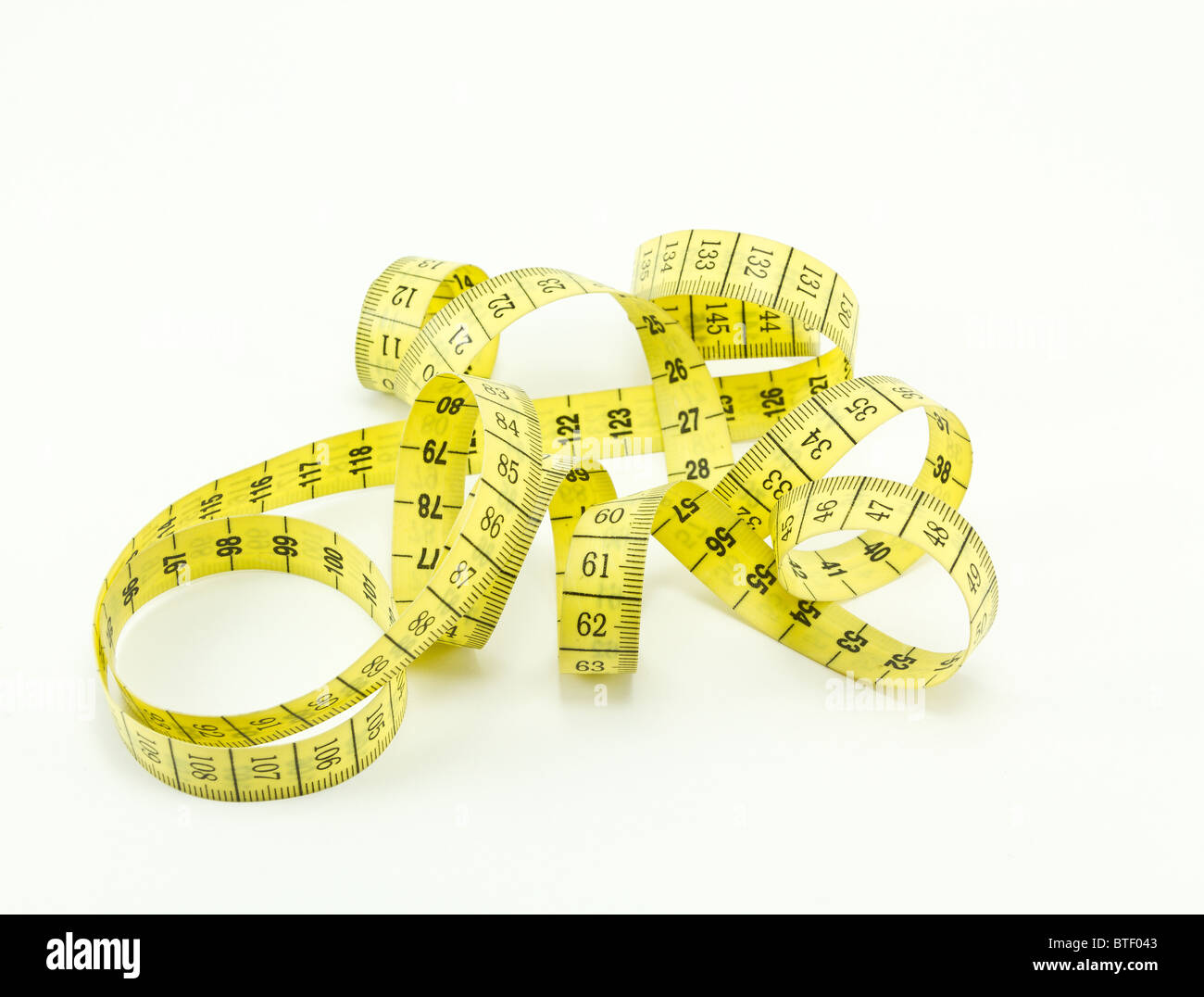 Yellow measuring tape isolated on white background Stock Photo - Alamy