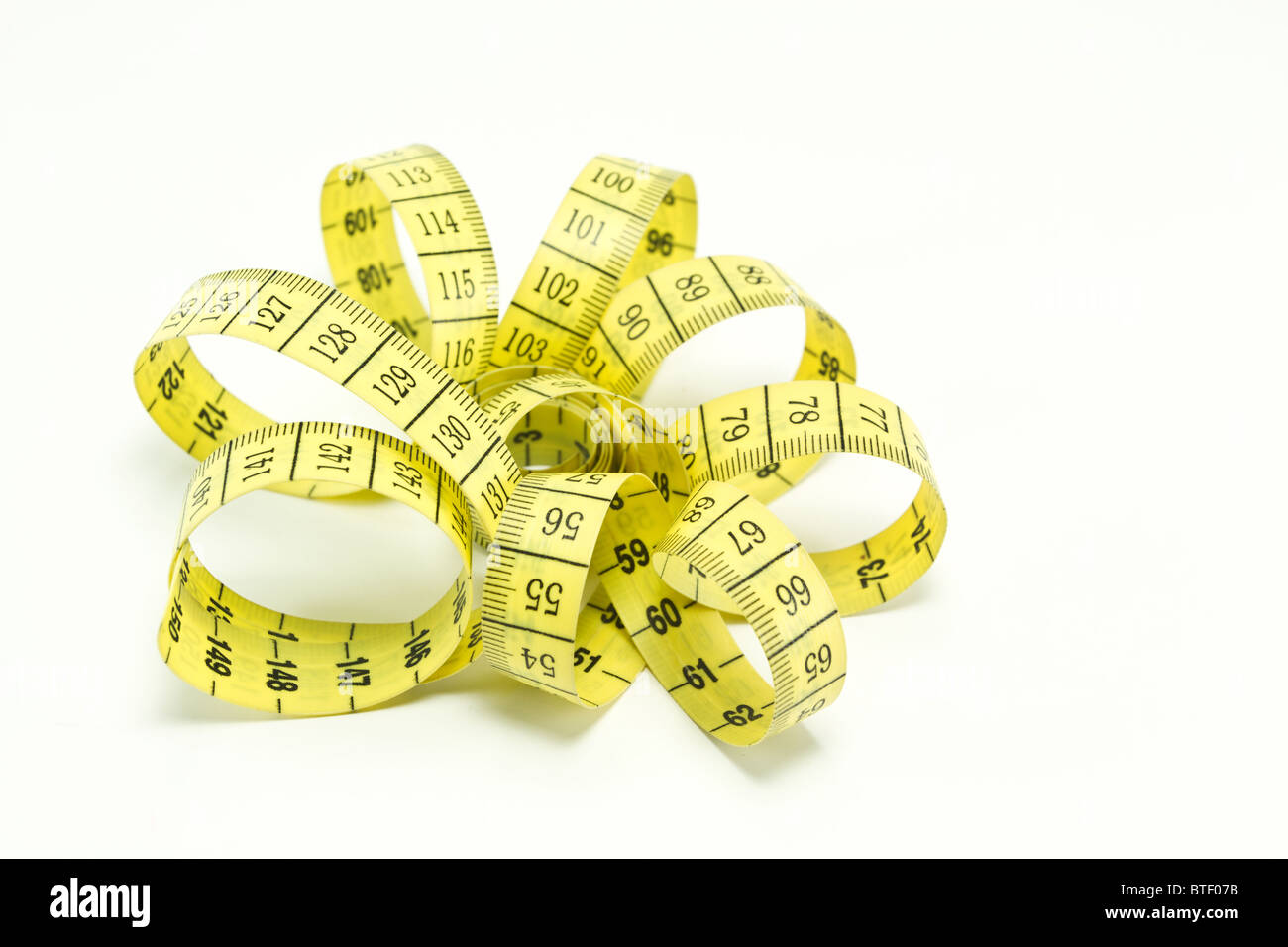 Yellow measuring tape isolated on white background Stock Photo - Alamy