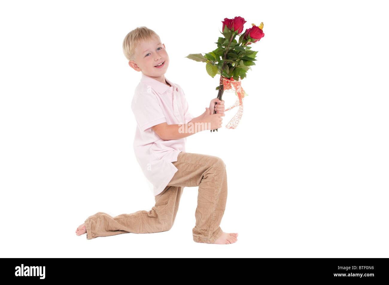 Smiling boy presenting red roses Stock Photo - Alamy